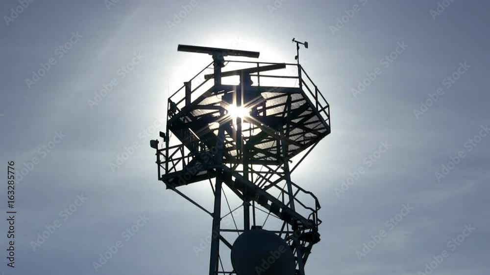 Marine traffic control radar tower silhouette with spinning antenna ...
