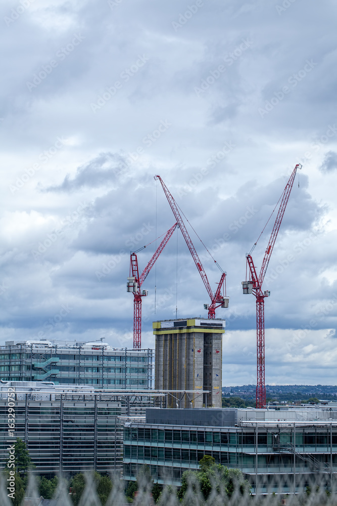 Construction industry over the London skyline. High rise tower building ...