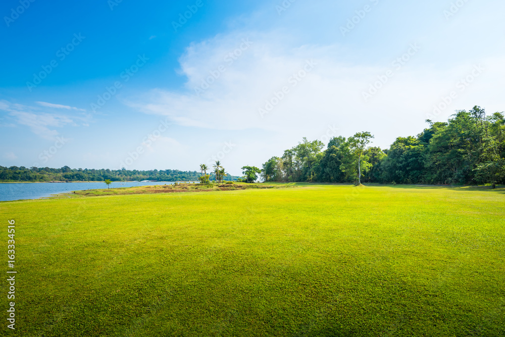 green grass field with lake in public park Stock Photo | Adobe Stock