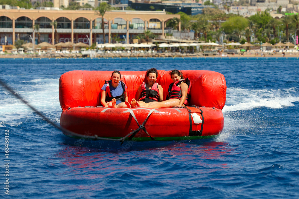 Happy people on water attractions Stock-Foto | Adobe Stock