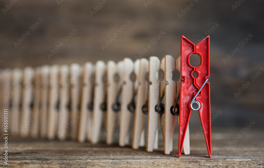 colorful clothespin against of ordinary clothespin abstract vision be ...