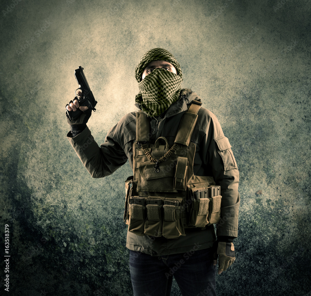 Portrait of a heavily armed masked soldier with grungy background Stock ...