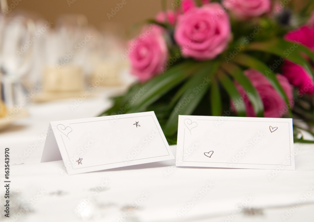 An empty blank paper table card name plate sign on a wedding table ...