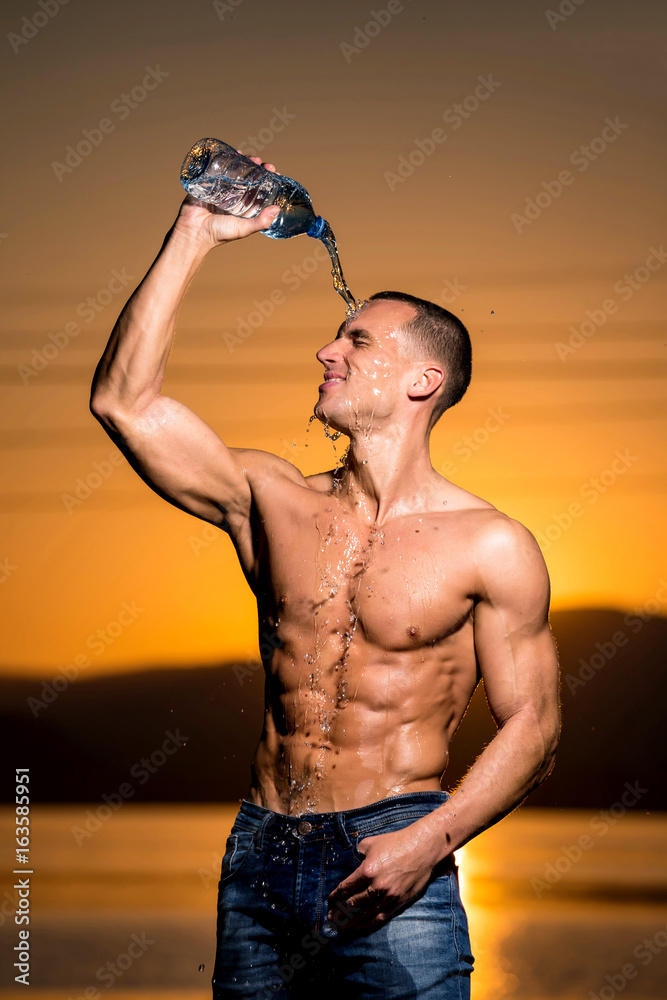 fitness muscular male model pouring water on face Stock Photo | Adobe Stock