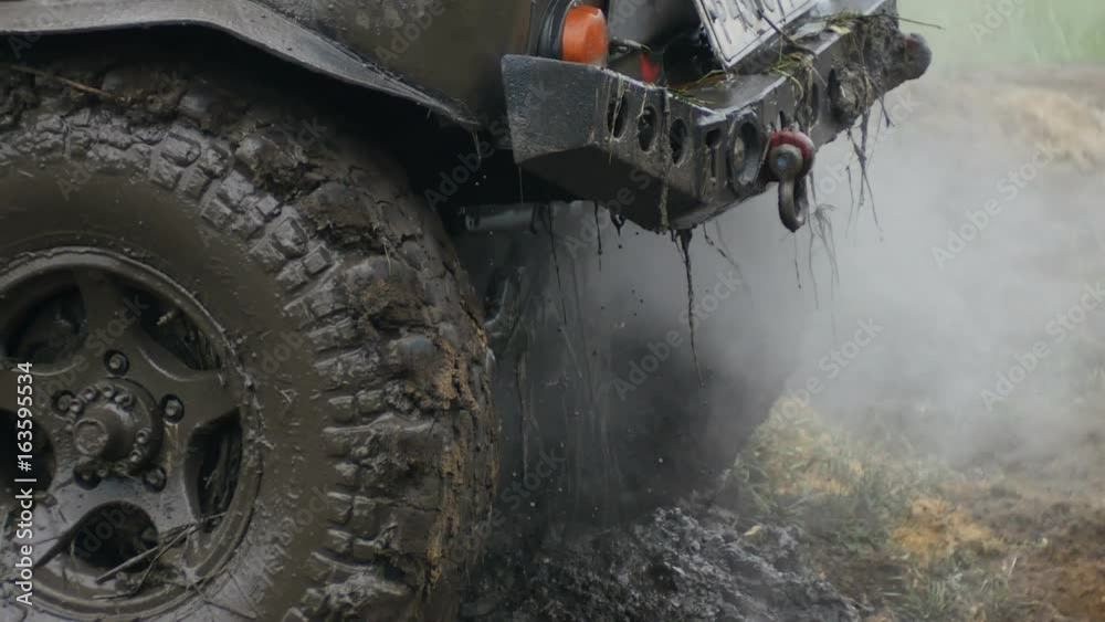 close up of wheel in the Mud. Off-road car wheel slips in the mud, but ...