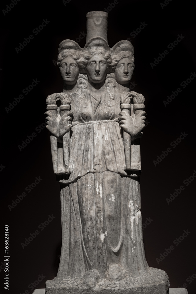 Three headed roman-asian ancient statue of beautiful women at black ...