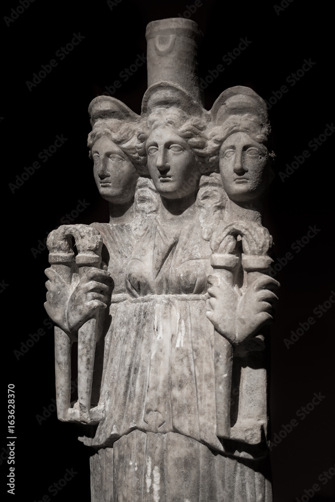 Three headed roman-asian ancient statue of beautiful women at bl Stock ...