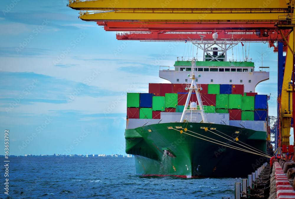 Port logistics, large container vessel berthing under many quay crane ...