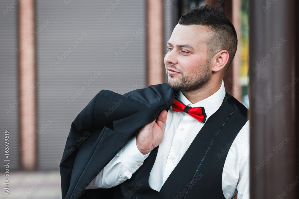 Young stylish man in a suit. Portrait of the groom. The groom is ...