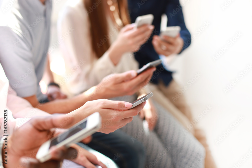Group of students watching smartphones. Young people addiction to new ...