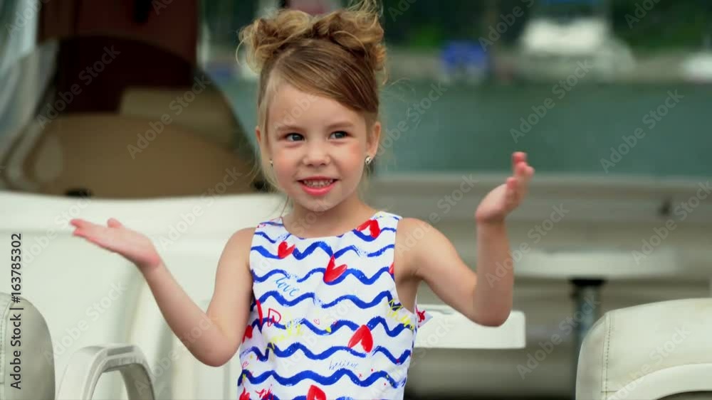 A bit the fair-haired girl poses on the boat for photos. The beautiful ...