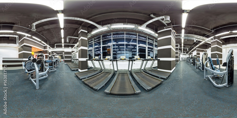 View of five treadmill in line and big windows at a big modern fitness ...