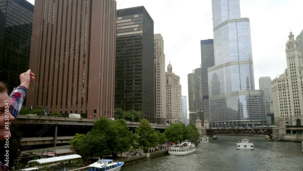Beautiful woman showing modern city buildings. Brunette woman showing ...