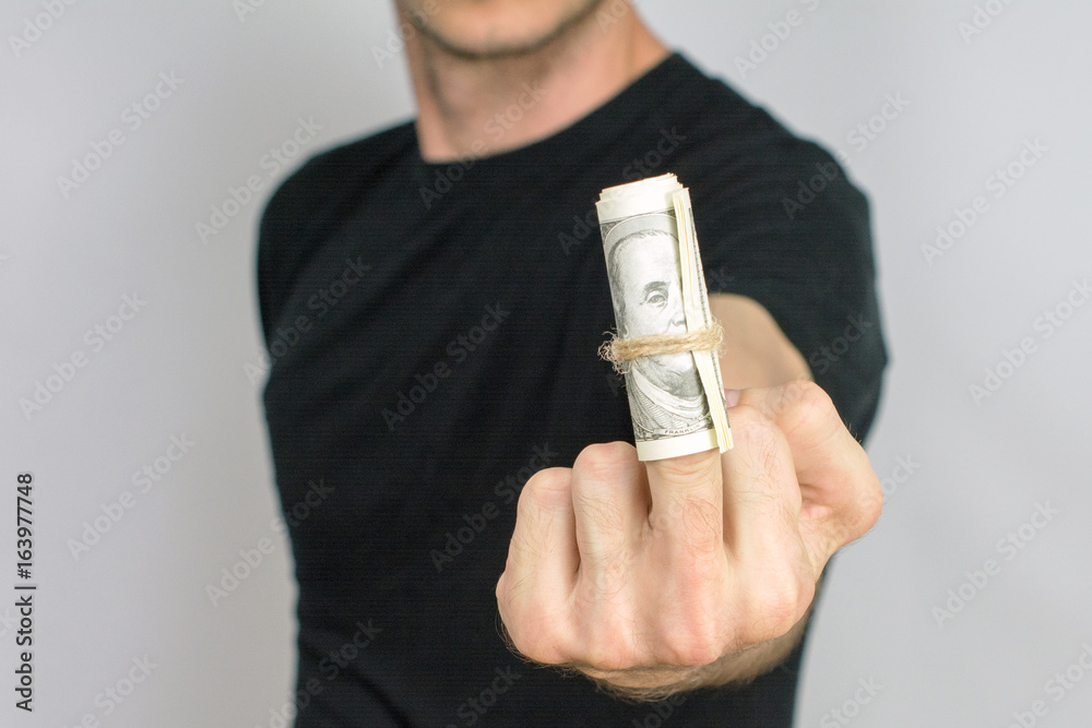 sign middle finger money hundred dollars bill man in a black t-shirt ...