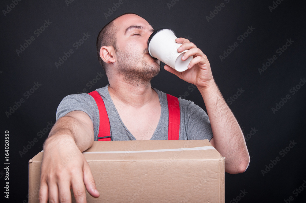Mover guy drinking coffee from takeaway cup Stock Photo | Adobe Stock