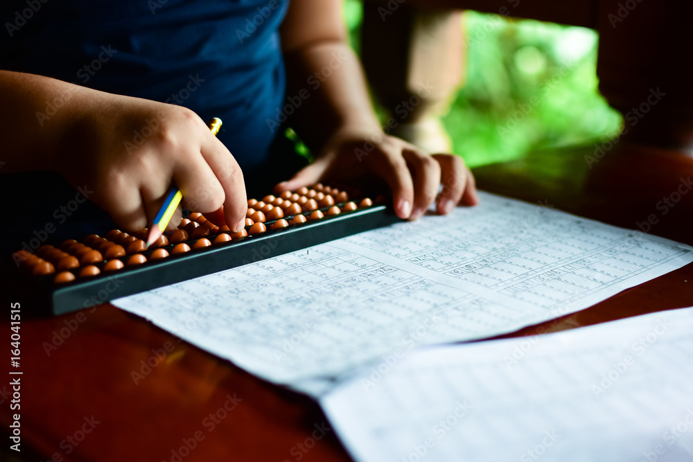 Cute little girl playing with abacus at home. Smart child learning to ...