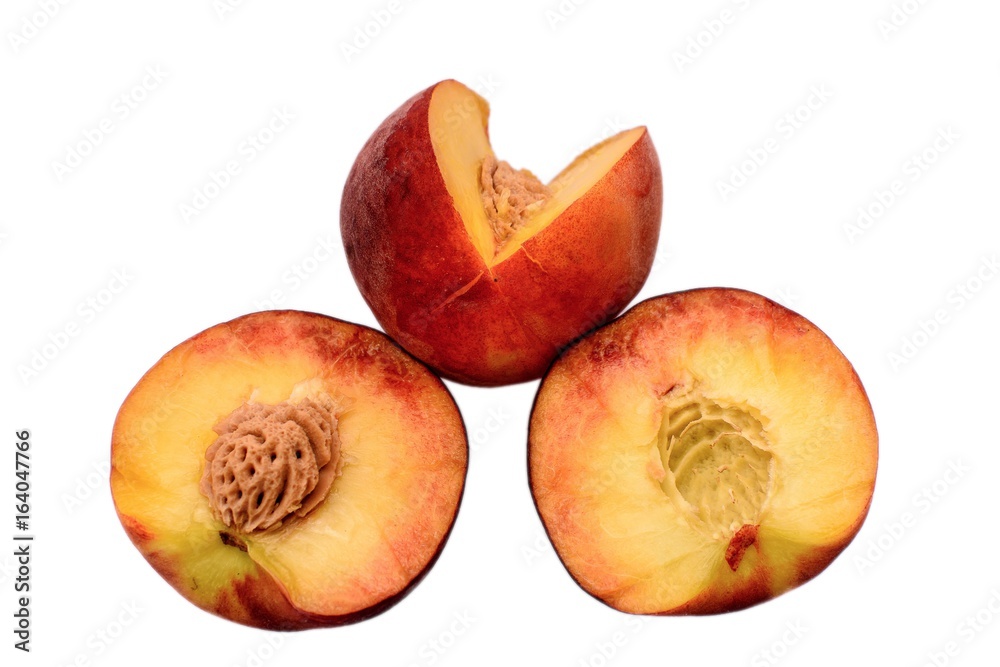 Peaches whole and sliced halves with a bone isolated on white ...