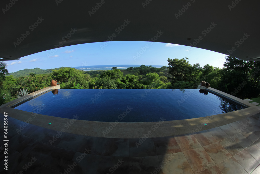 Infinity pool of a luxury house with view of the rainforest and beach ...