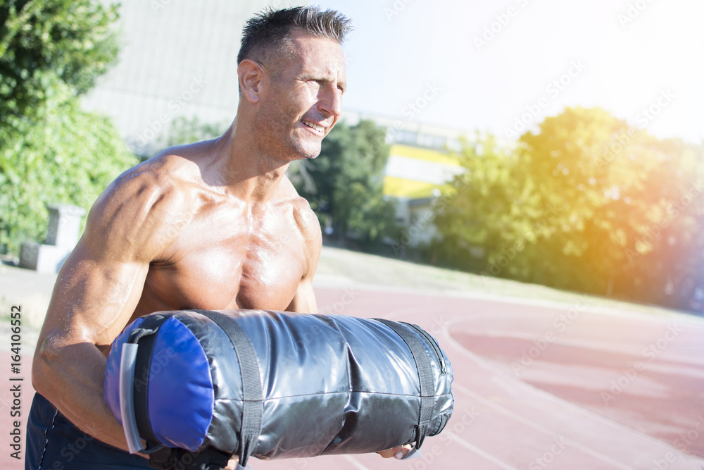 Handsome middle aged man working out on a running track. Healthy adult ...