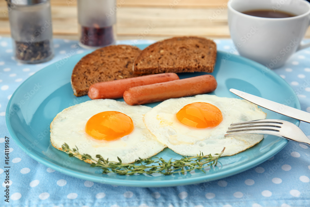 Homemade over easy fried eggs with sausages and bread on plate Stock ...