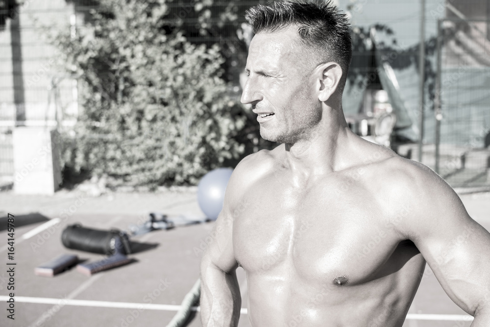 Handsome middle aged man working out on a running track. Healthy adult ...