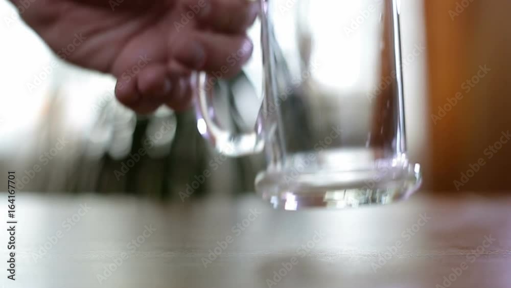 Half empty beer mug on table changed to empty / Half empty beer mug on ...