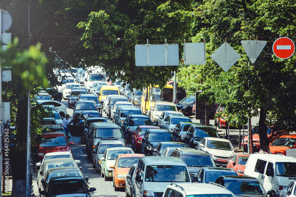 Road traffic, congestion on a city road. A car with a high load. The ...