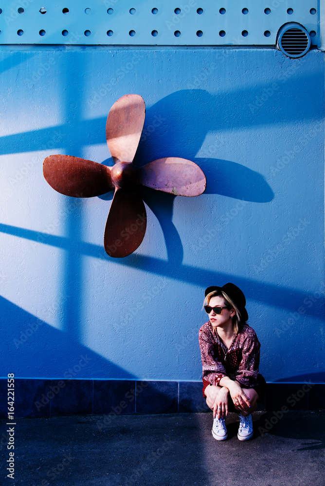 Girl model posing near the wall in the afternoon Stock Photo | Adobe Stock