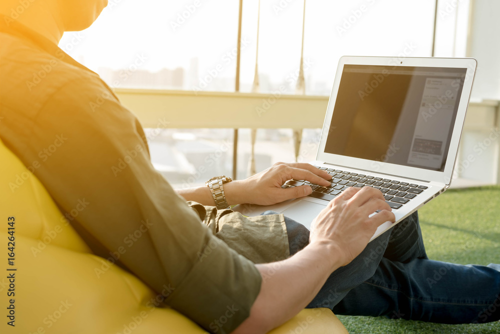Young man use smartphone and laptop in afternoon, technology lifestyle ...