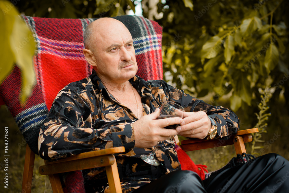 Foto de Close-up portrait of a senior man thinking about something. A ...