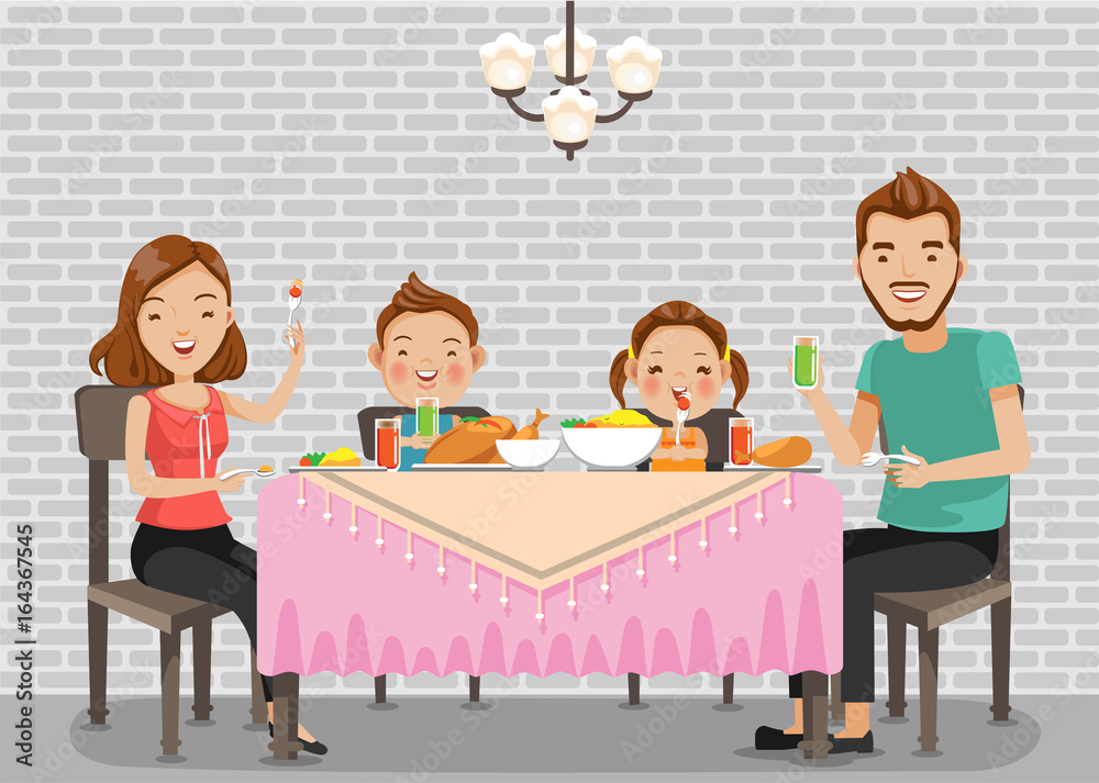 Family meal.Father, mother,son and daughter together happily sit at the ...