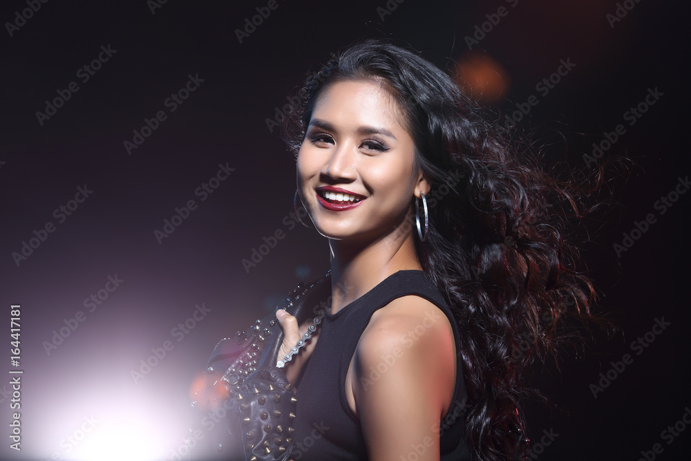 low key portrait of tan skin asian slim healthy woman in black ...