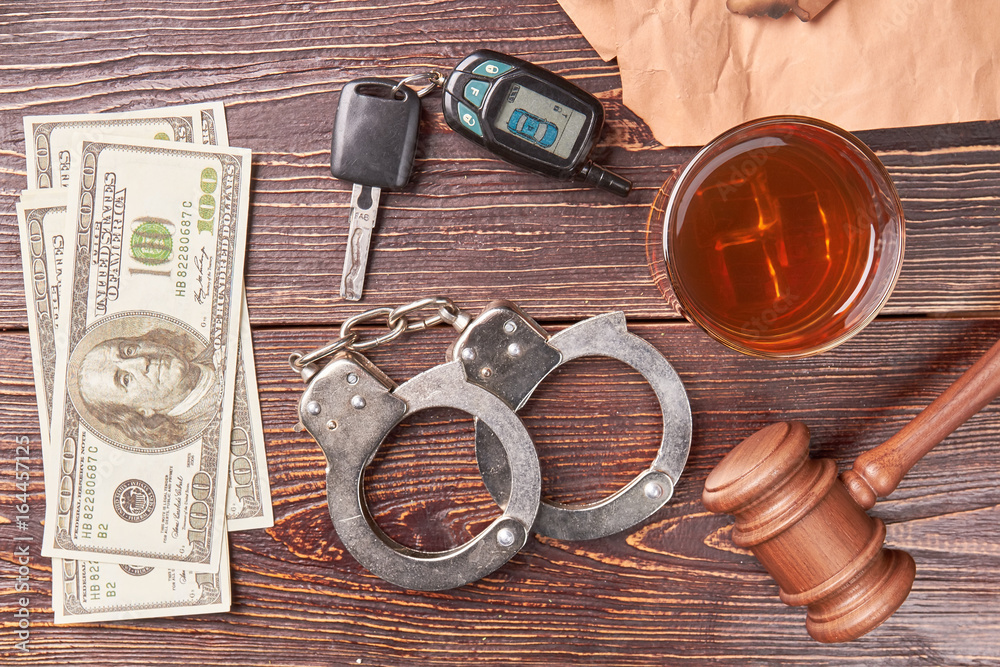 Money, handcuffs, whiskey, key, gavel. Pair of handcuffs, car keys ...