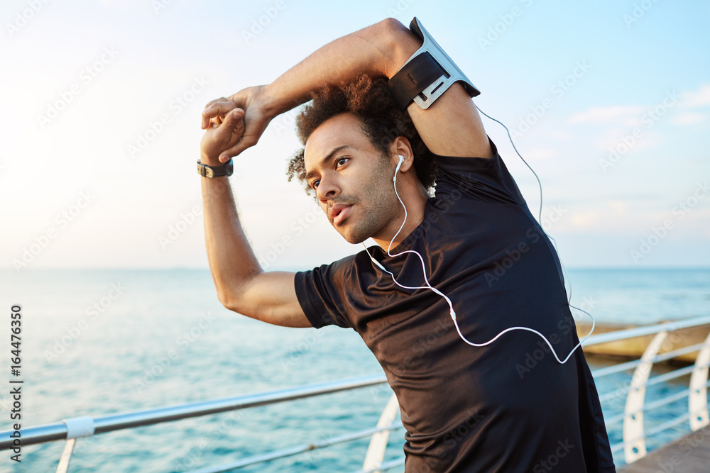 Dark-skinned male runner with beautiful athletic body and bushy ...