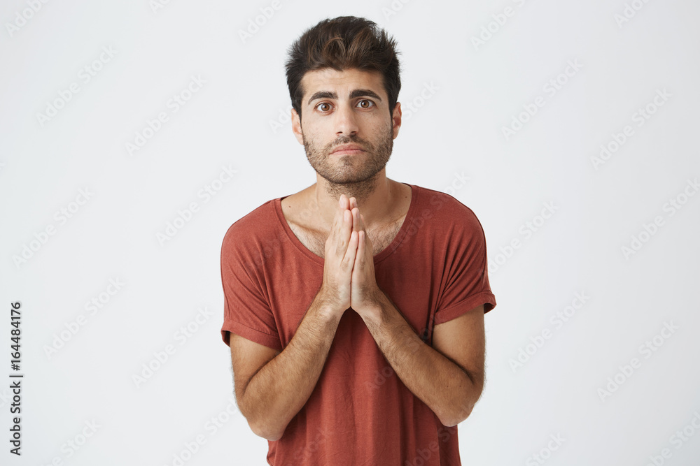 Handsome attractive disappointed guy pledging for something. Man ...