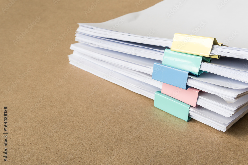 blank document papers with paper clips pastel color on brown paper ...