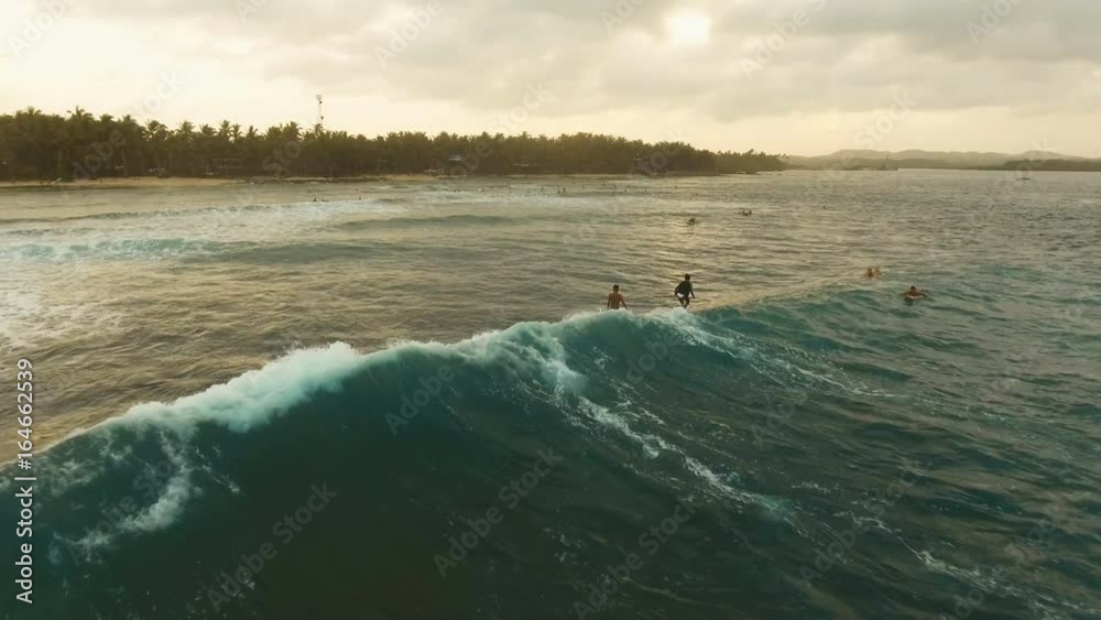 Surfers at sunset in siargao islands famous surf break cloud 9 near ...