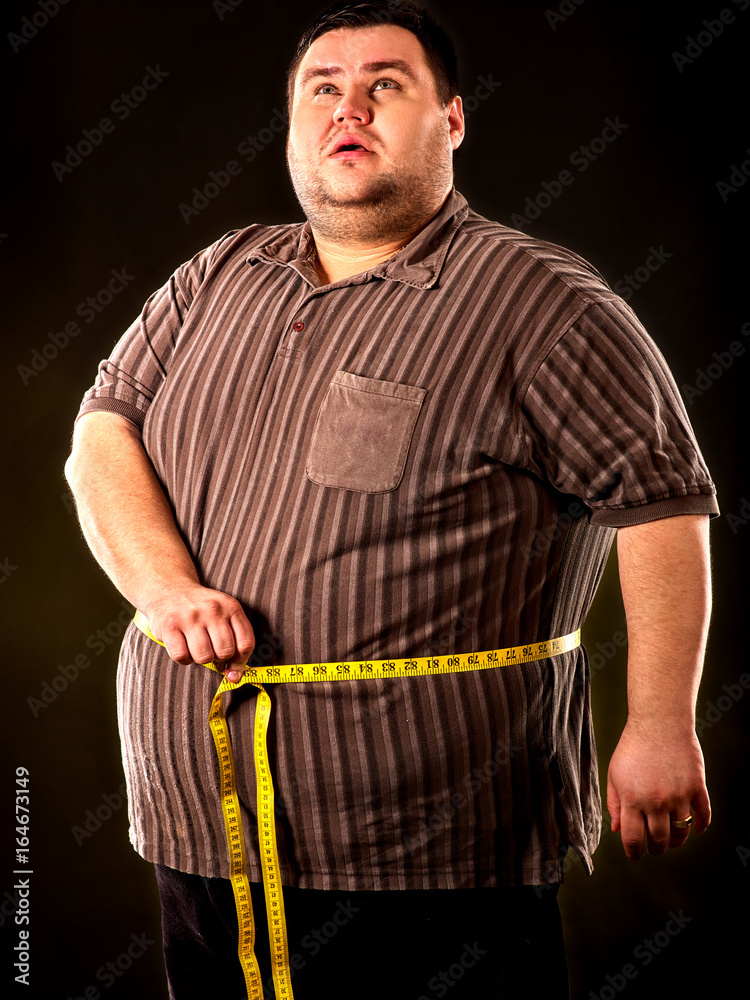 Man belly fat with tape measure weight loss around body on black ...