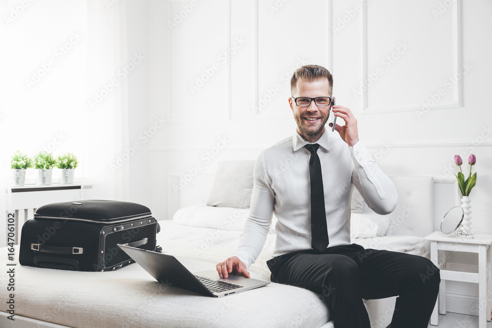 Businessman working from a hotel room with his mobile phone Stock Photo ...