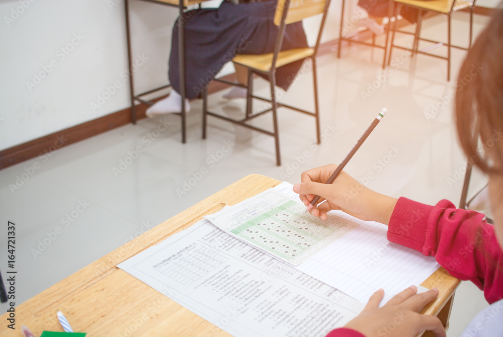 Asian Student hand holding pencil writing doing test examination and ...