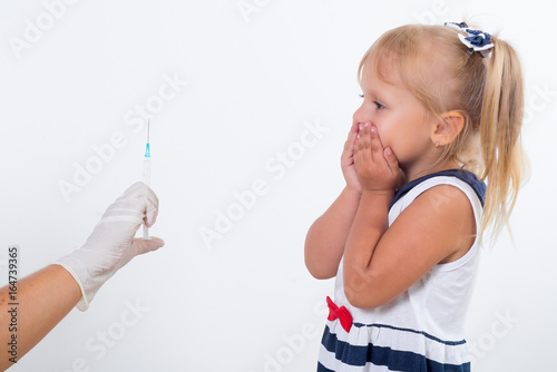Doctor holds syringe to vaccinate sick baby with injection. Crying and ...