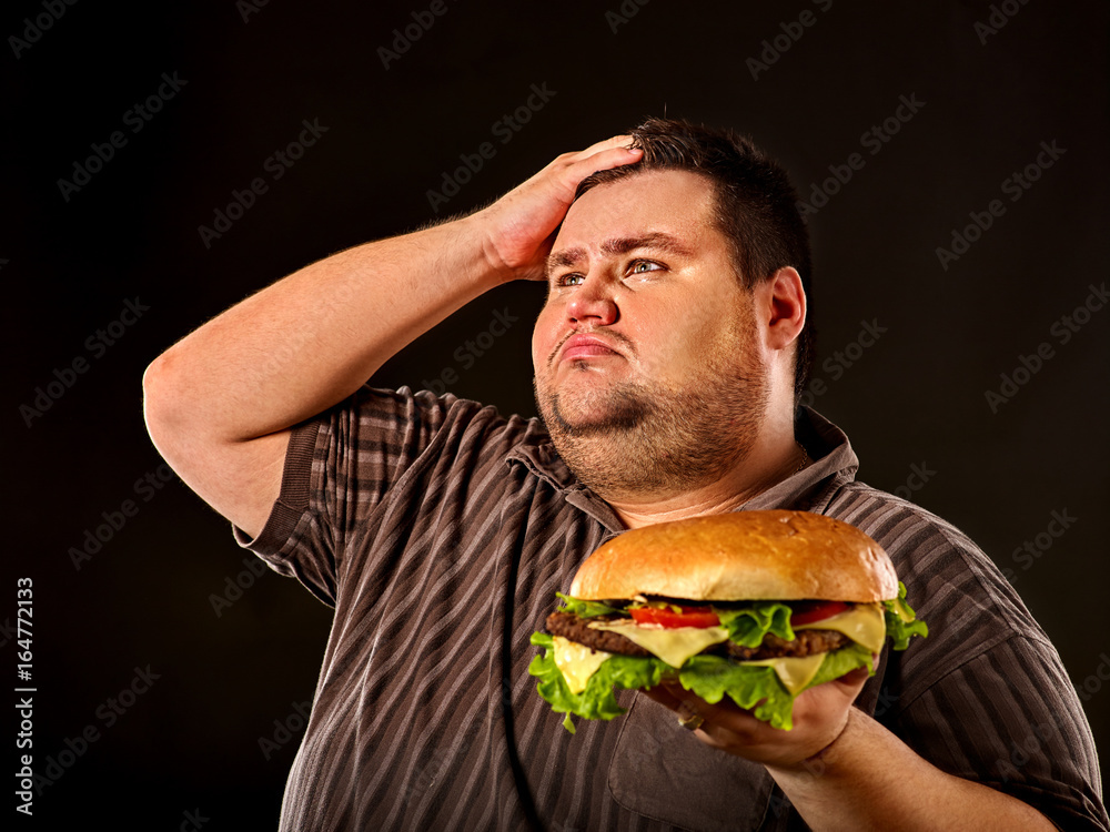 Foto de Man eating fast food hamberger. Fat person made great huge ...