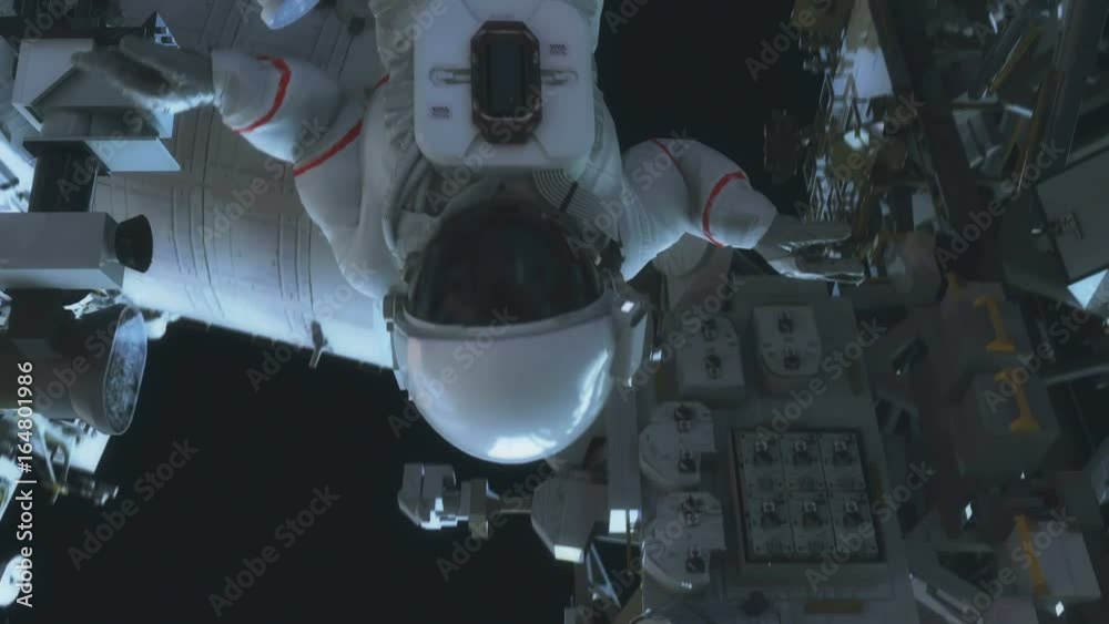 An astronaut on a spacewalk at the International Space Station. Highly ...