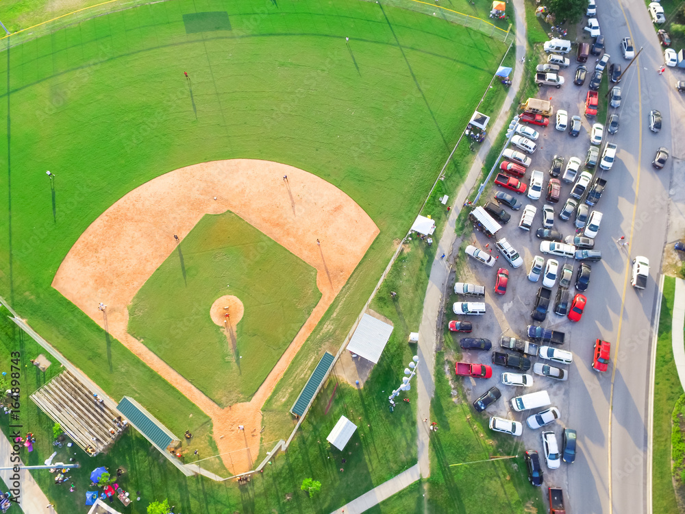 Aerial view a large baseball stadium, full cars at outdoor parking lots ...