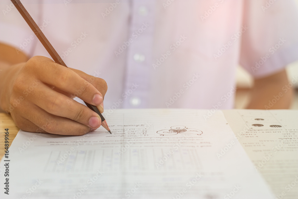Blurred of Asian boy students hand holding pencil writing fill in Exams ...