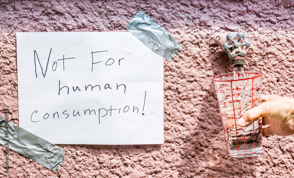 horizontal image of a sign saying "not for human consumption" beside an ...