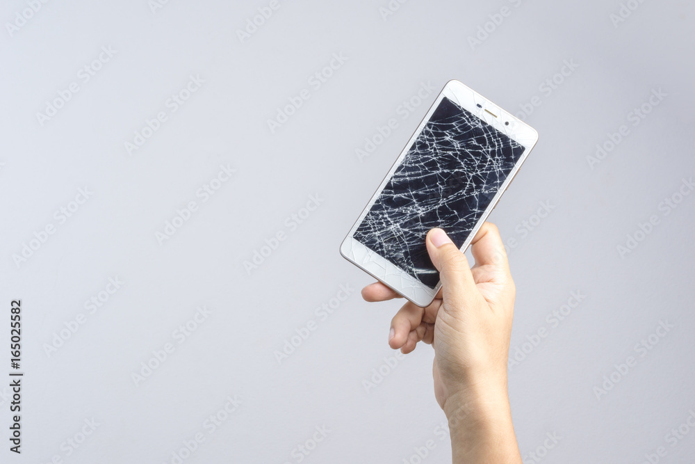 Hand holding mobile phone with broken screen Stock Photo | Adobe Stock