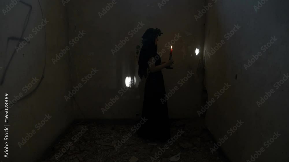 Demonic gothic evil woman turning around holding a candle and angrily ...