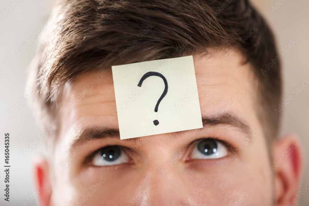 Businessperson's Forehead With Question Mark On Sticky Note Stock Photo ...
