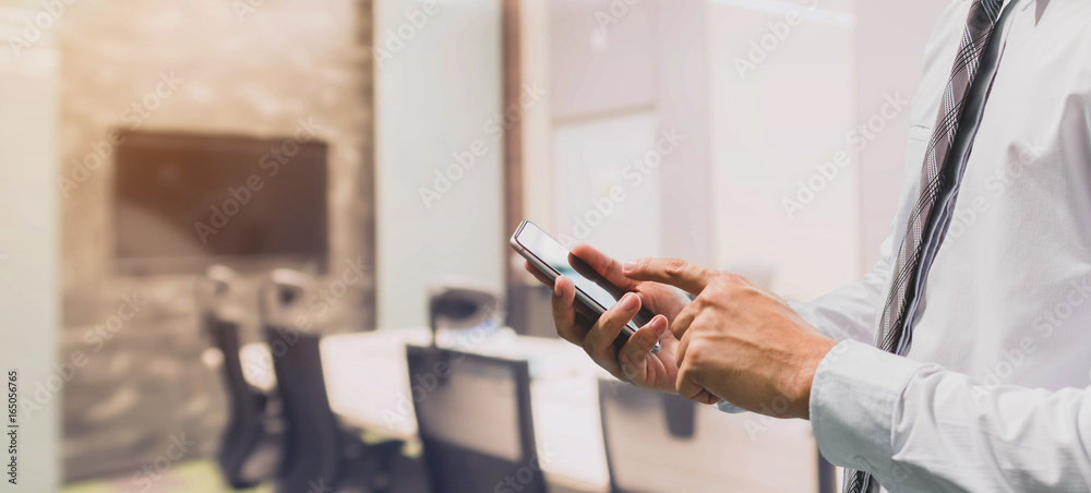 Businessman using smart phone in meeting room interior background and ...